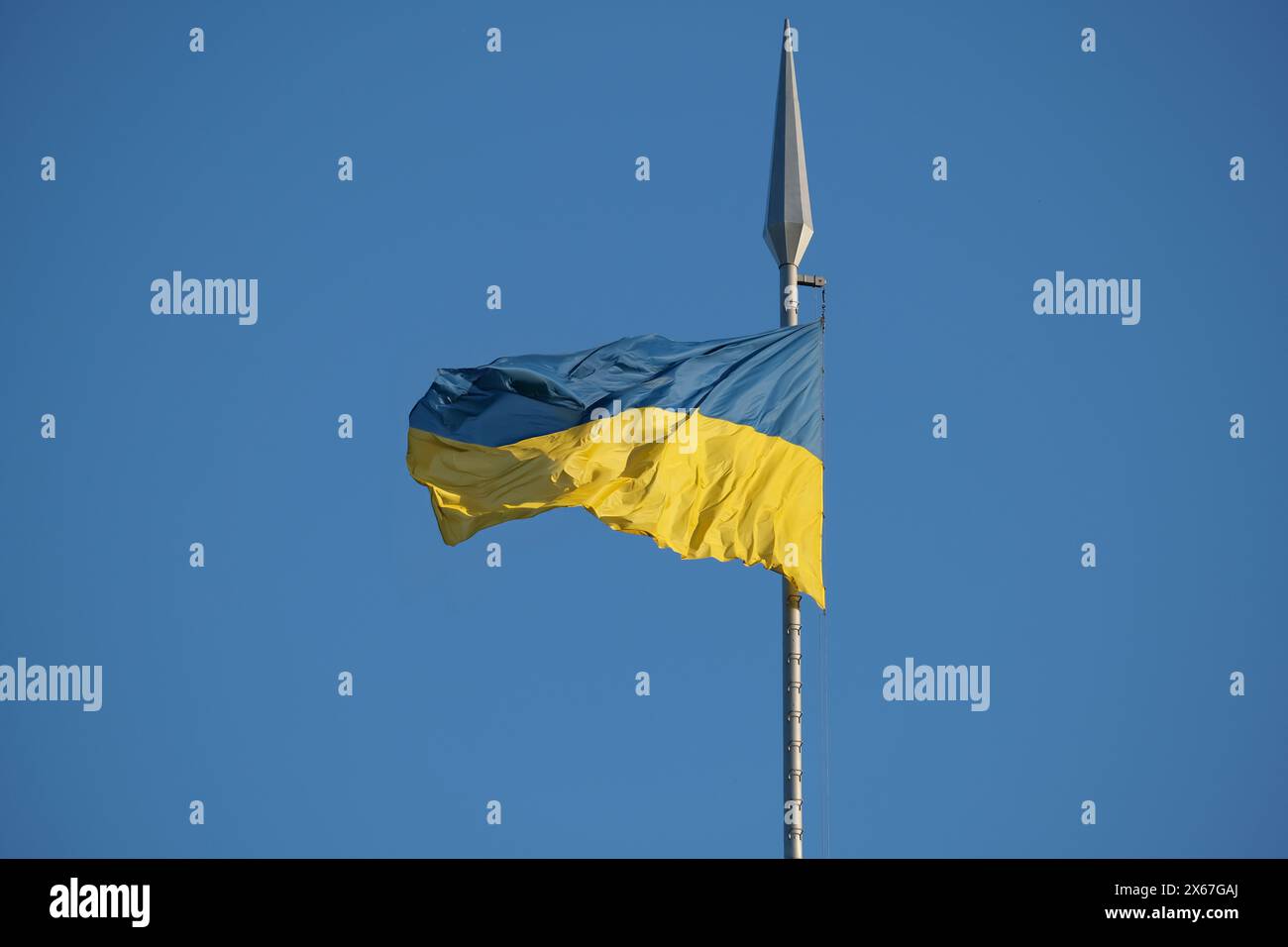 Ukrainian flag against of a serene blue sky. Symbol of the freedom of ...