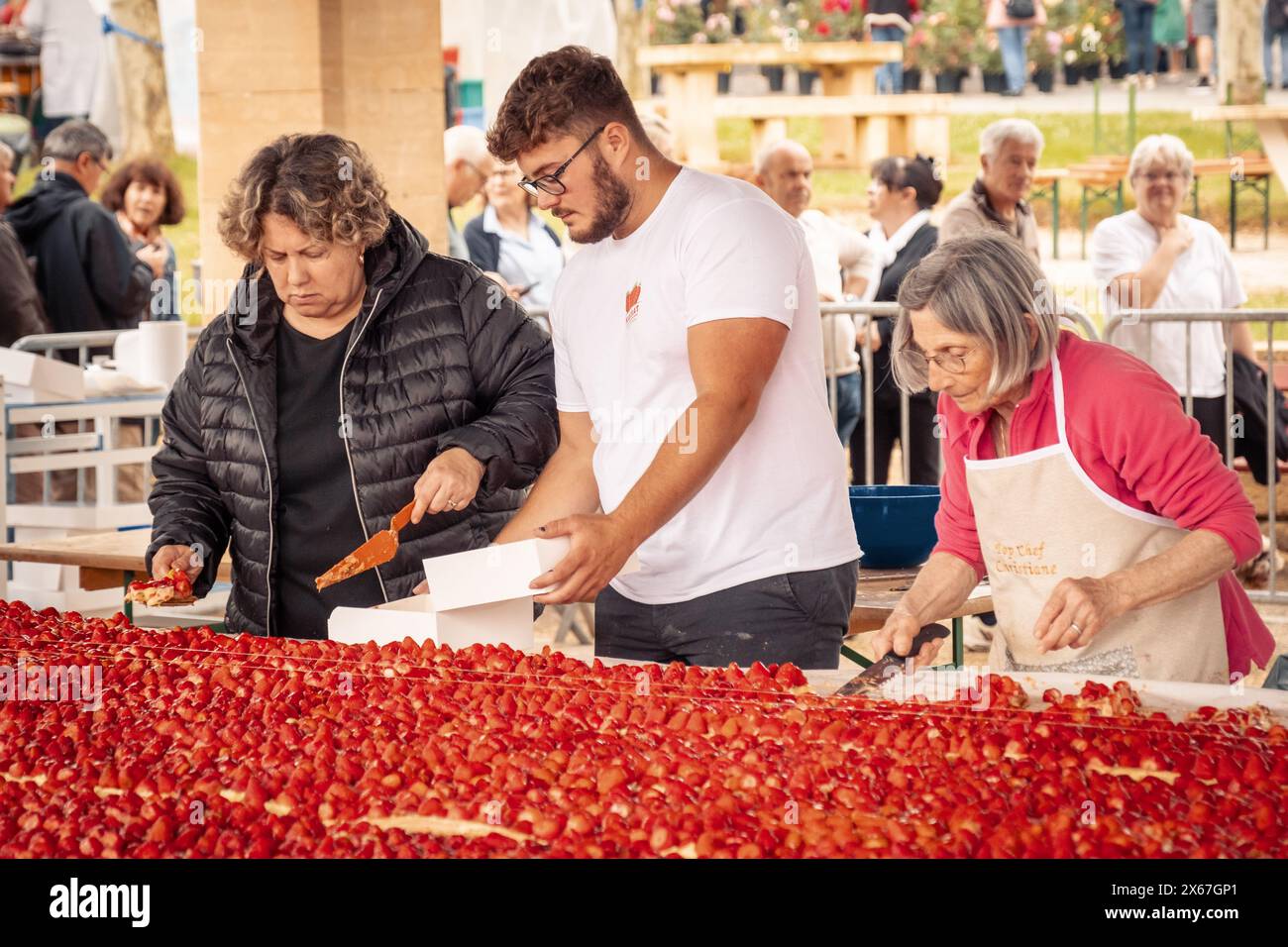 Nabirat, Nouvelle-Aquitaine, France - 12th May 2024: Volunteers serve ...