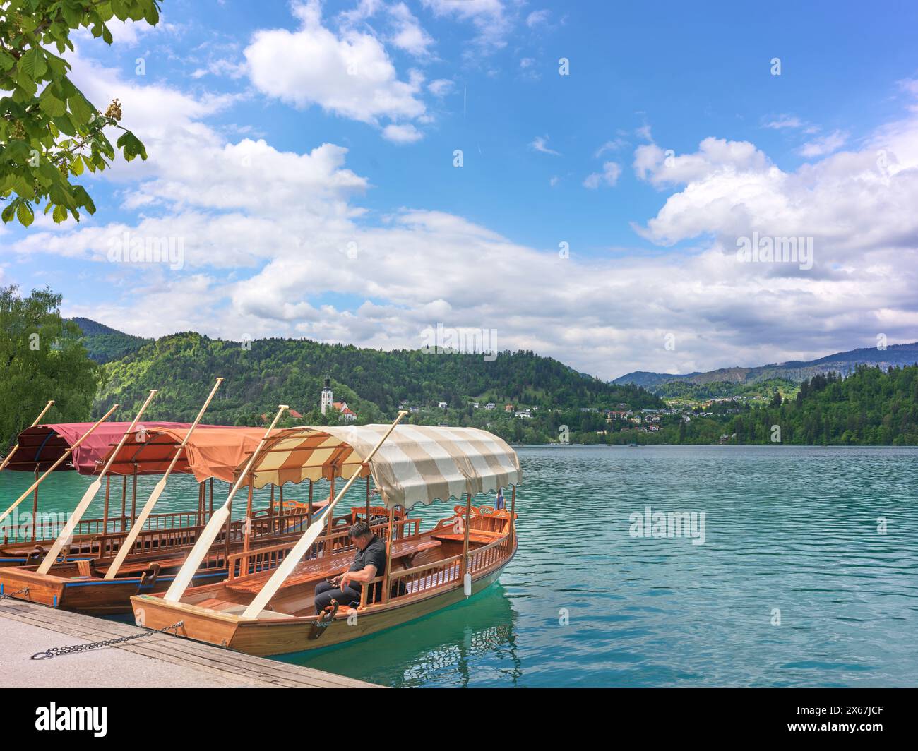 Oarsman sits in his pletna rowing boat waiting for tourists to take a ...