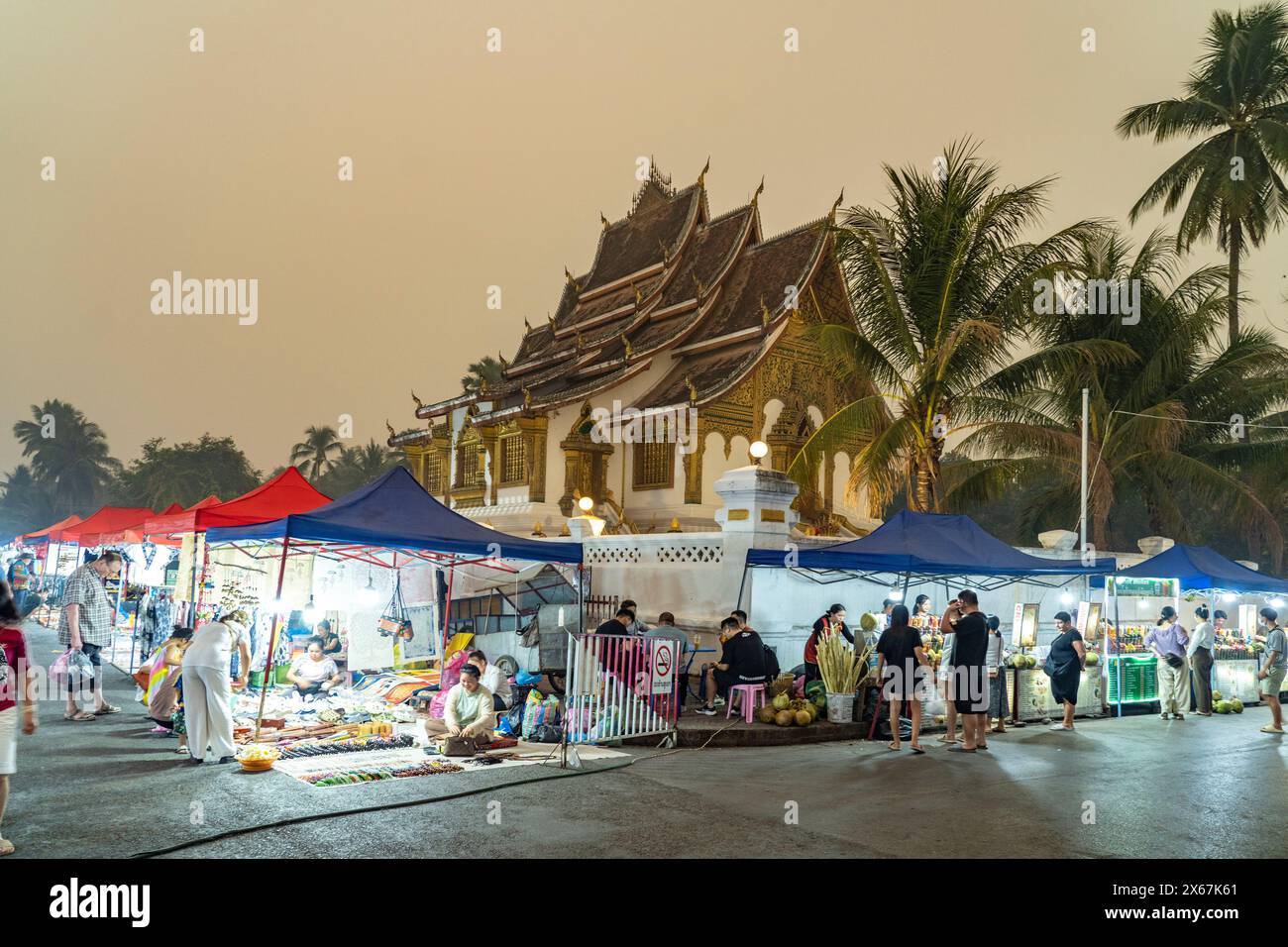 Night market and the Haw Pha Bang temple of the Royal Palace in Luang ...