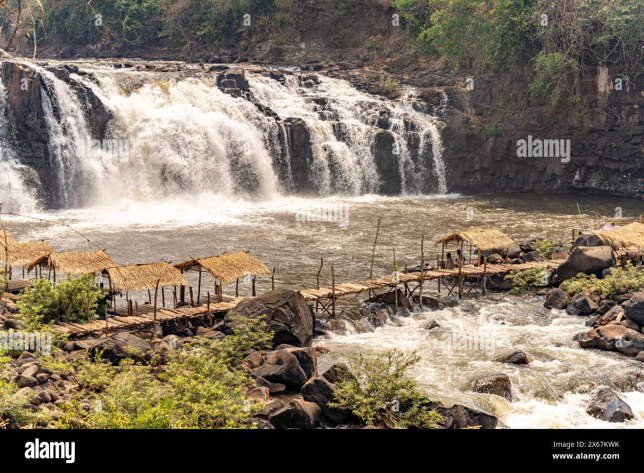 Wooden bridge at the Tad Lo waterfall in the Bolaven Plateau, Laos ...