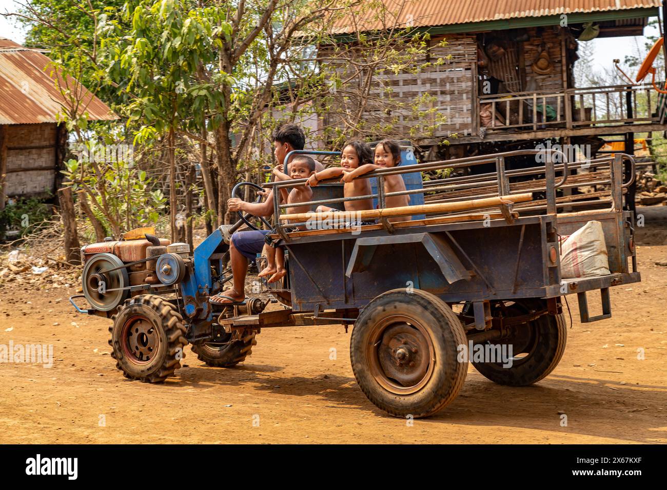 Children on a two-wheel tractor in the village of Ban Baktheung in the ...