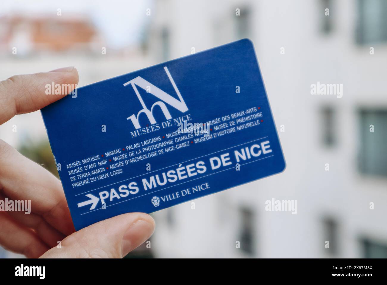 Nice, France - 27.01.2024: A man's hand holds a card for visiting the ...