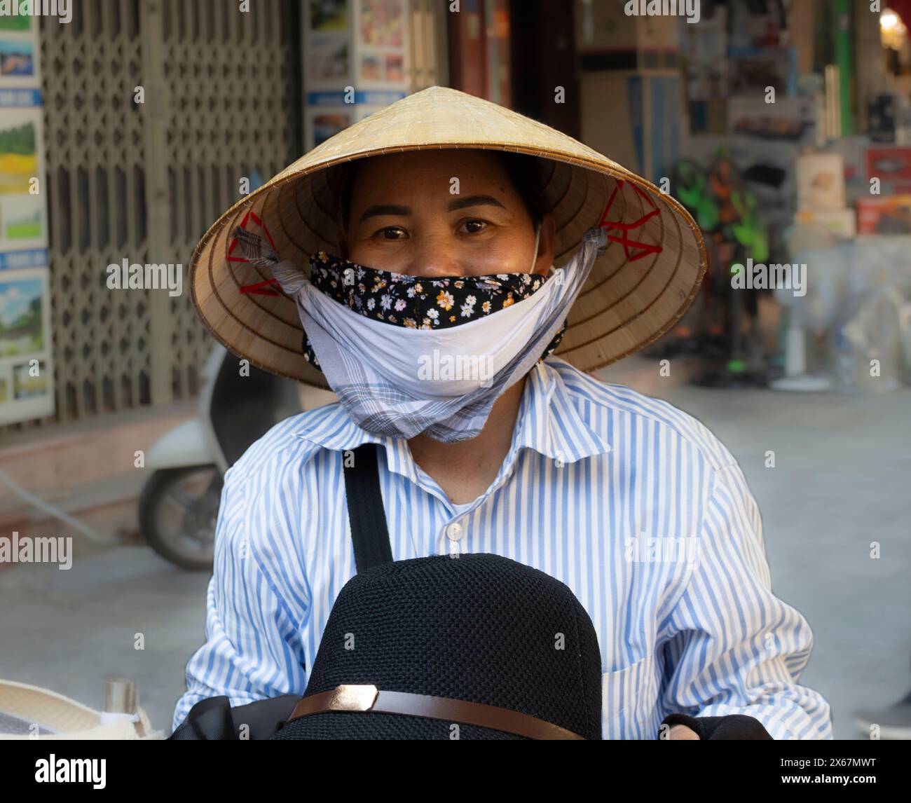 Street seller with mask, Hanoi Stock Photo - Alamy