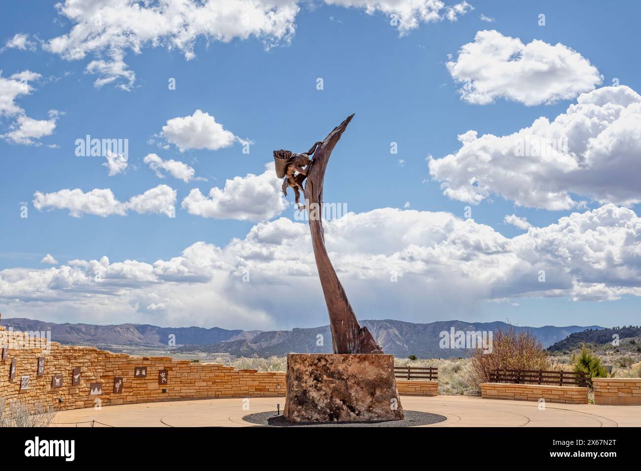Sculpture of an ancestral Puebloan climbing up a cliff face called The ...
