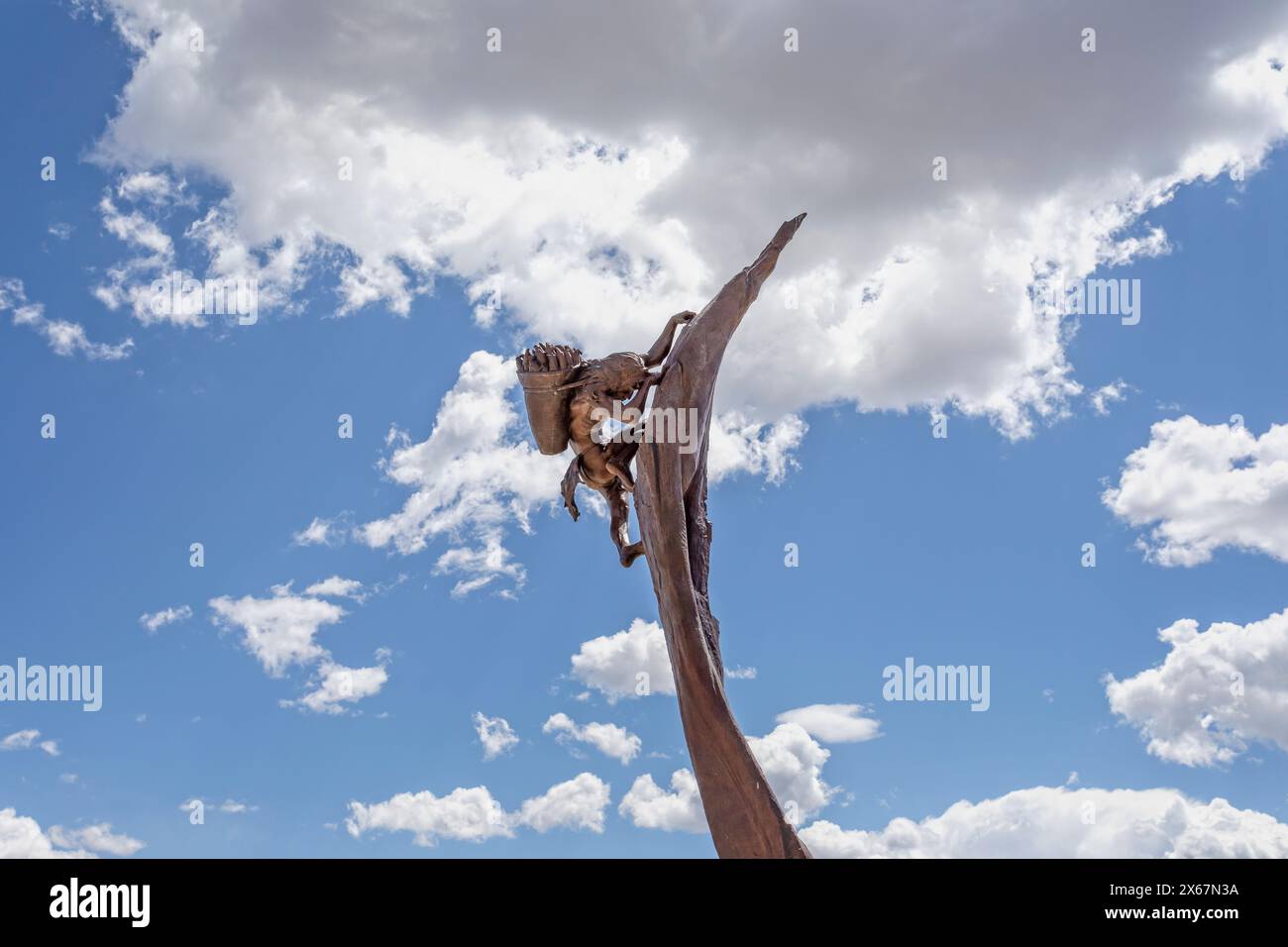 Sculpture of an ancestral Puebloan climbing up a cliff face called The ...