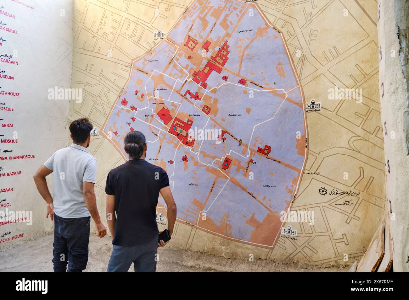 Two young men look at the city map showing major tourist attractions in ...