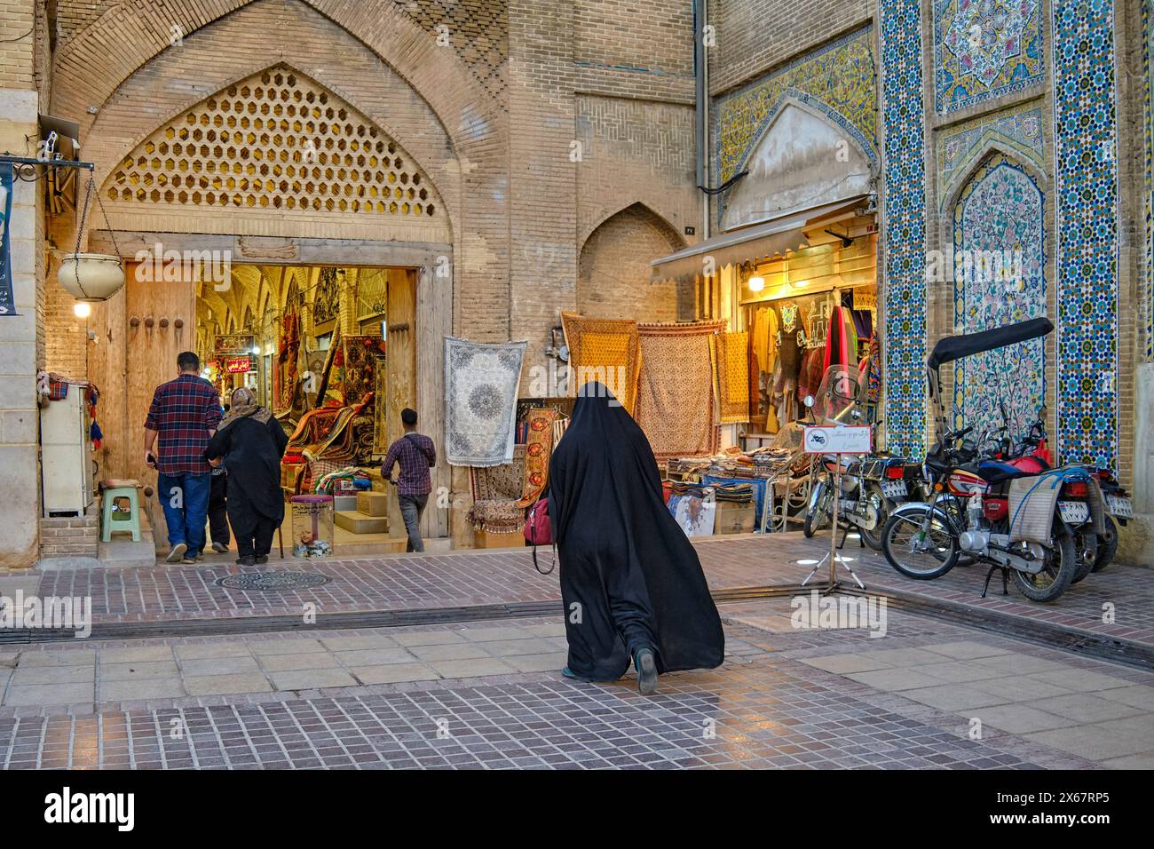 Iranian woman wearing traditional black chador walks towards the ...