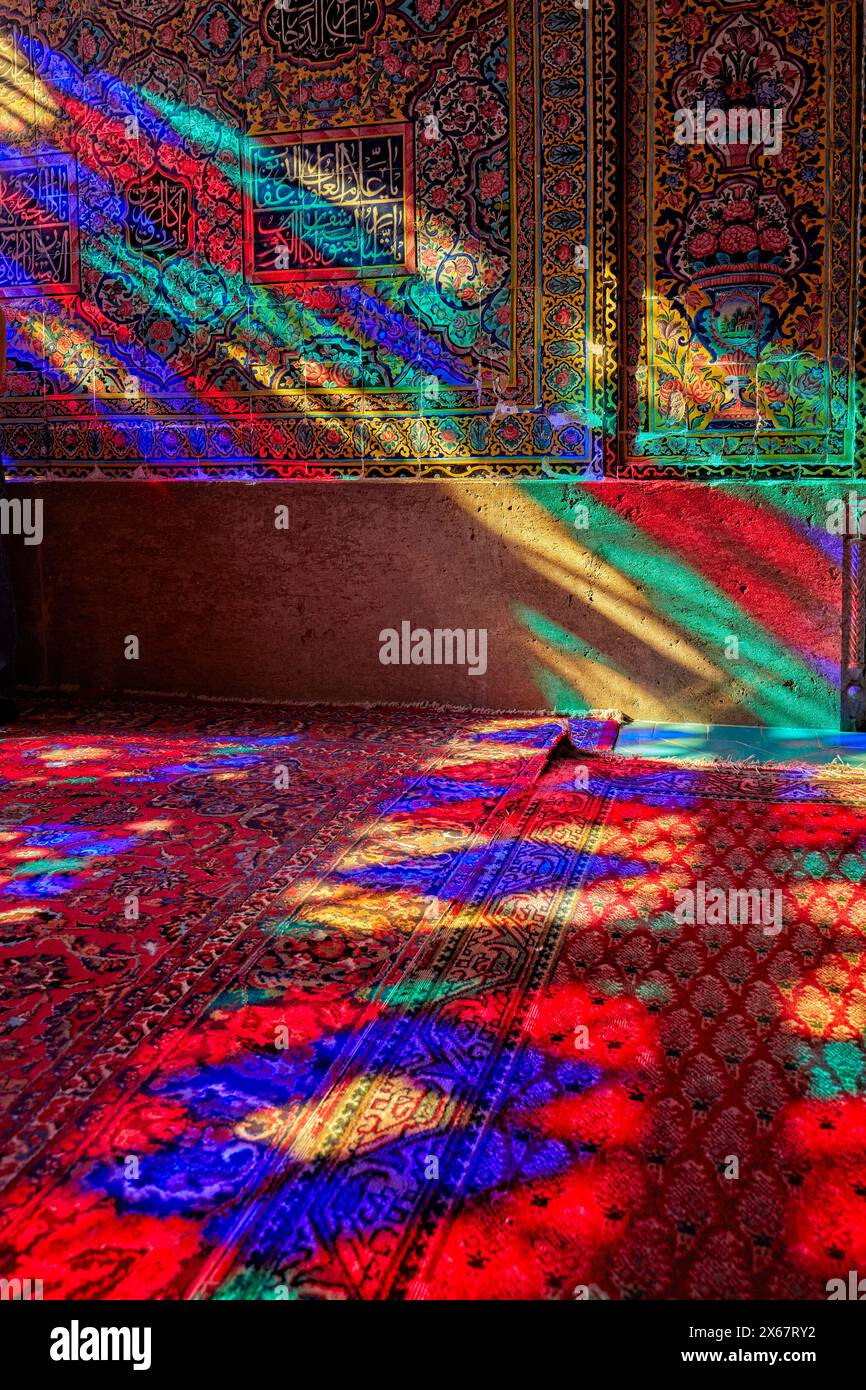 A play of light from multi-colored stained-glass windows inside the ...