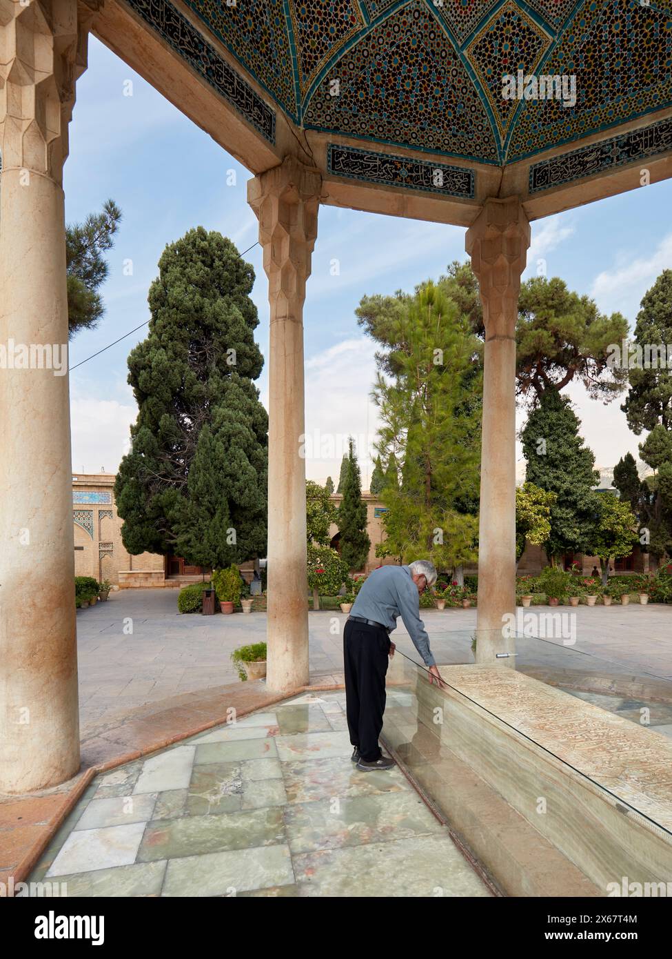 Senior Iranian man at the tomb of Hafez, one of the greatest Persian ...
