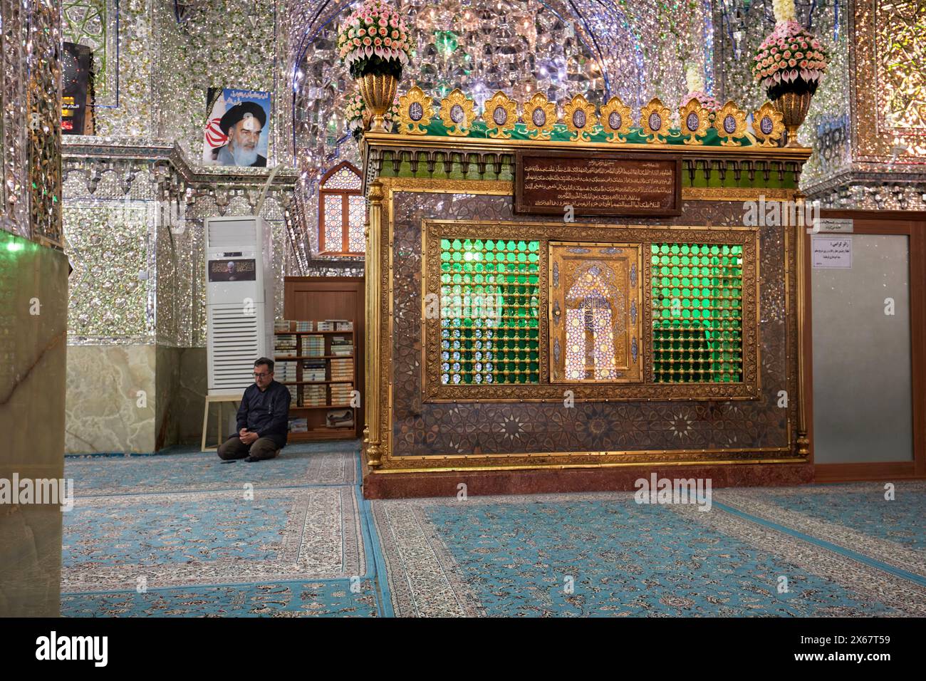 A man prays in the Ali Ibn Hamzeh Holy Shrine elaborately decorated ...