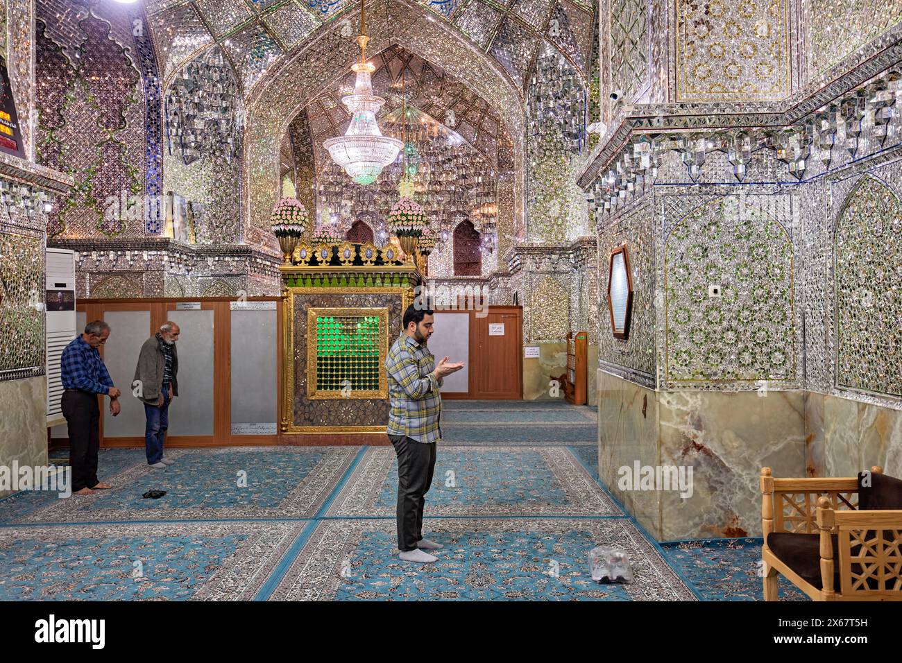 Men pray in the Ali Ibn Hamzeh Holy Shrine elaborately decorated inside ...