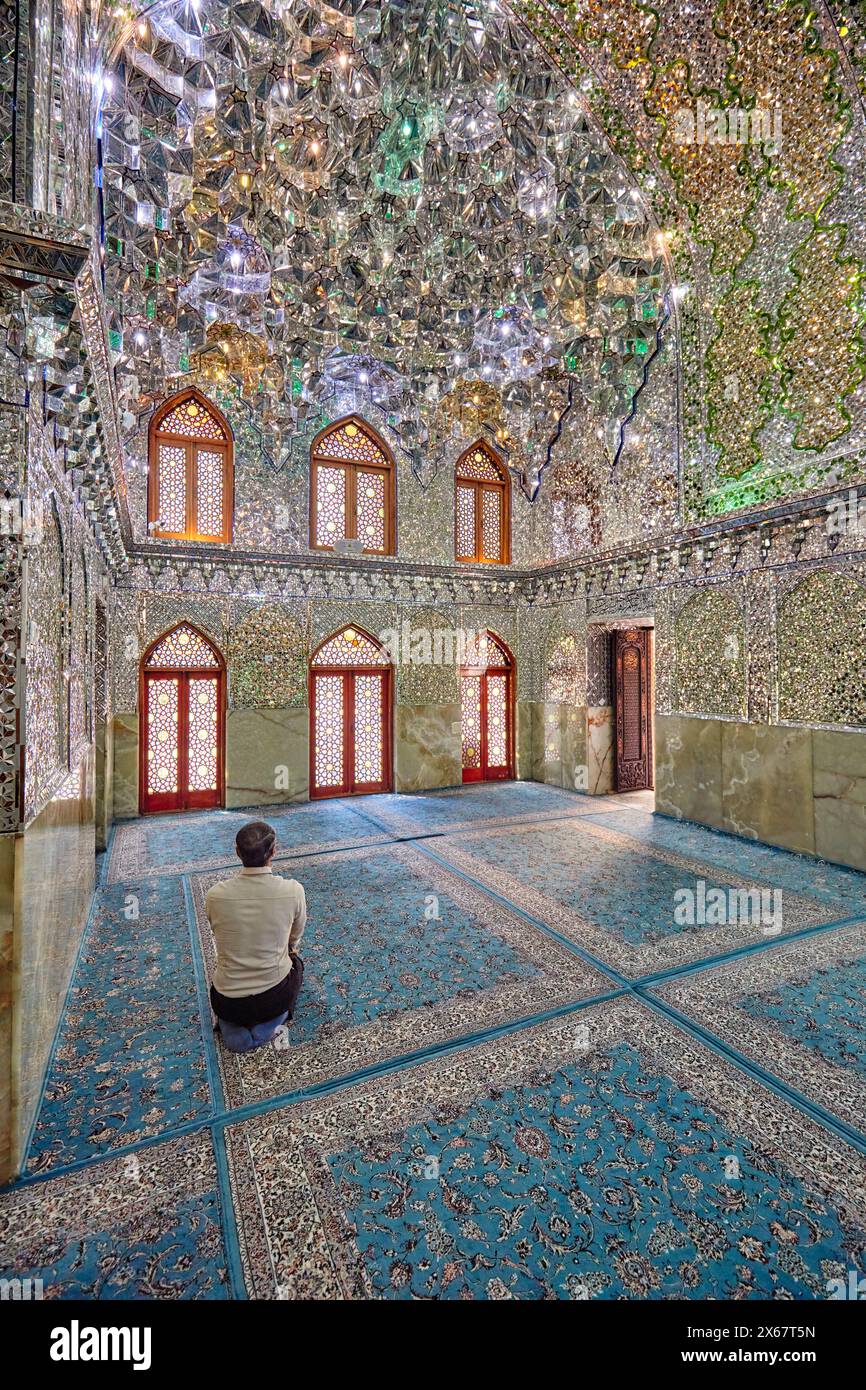 A man prays in the Ali Ibn Hamzeh Holy Shrine elaborately decorated ...