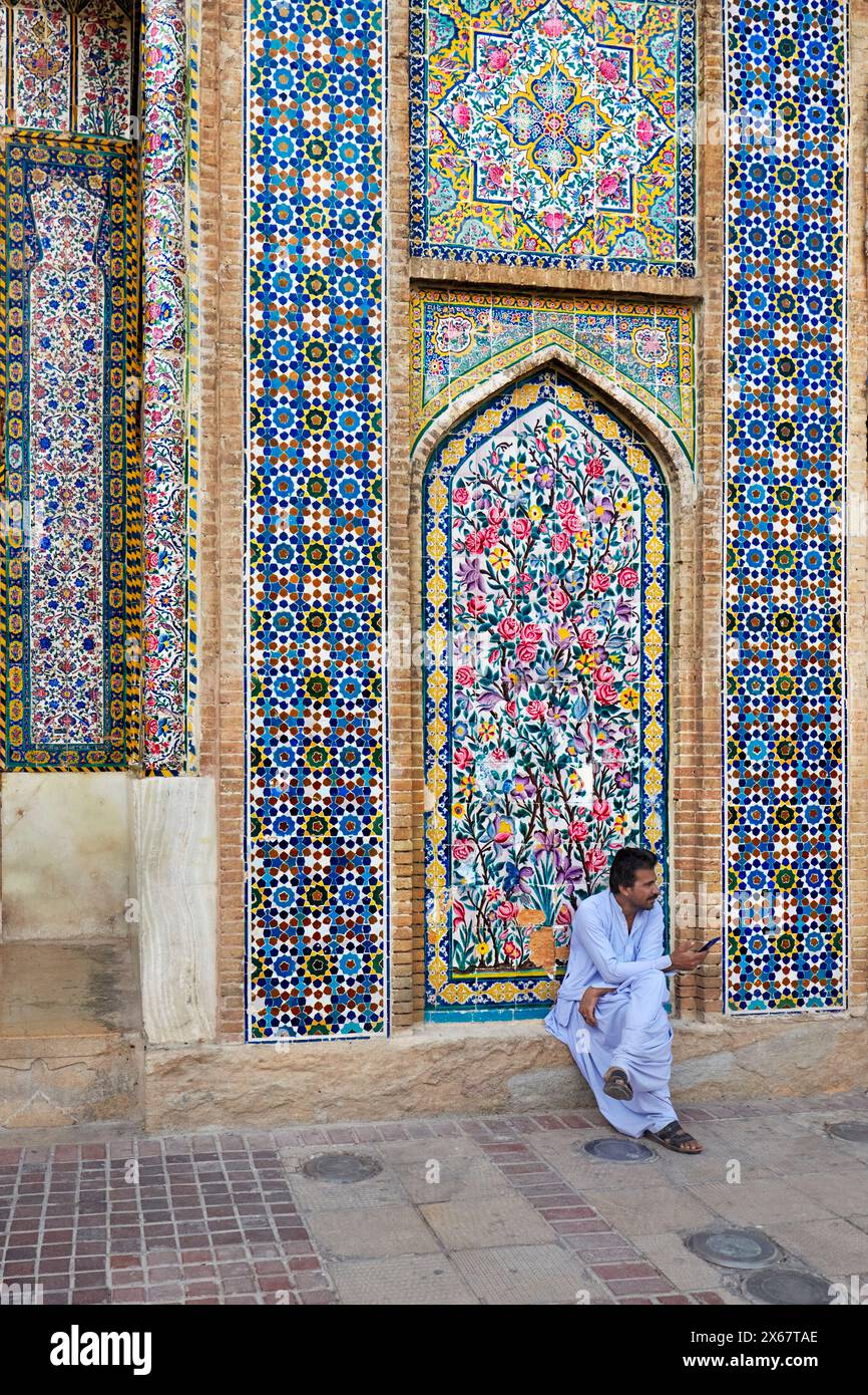 Iranian man wearing traditional costume sits at the 18th century Vakil ...