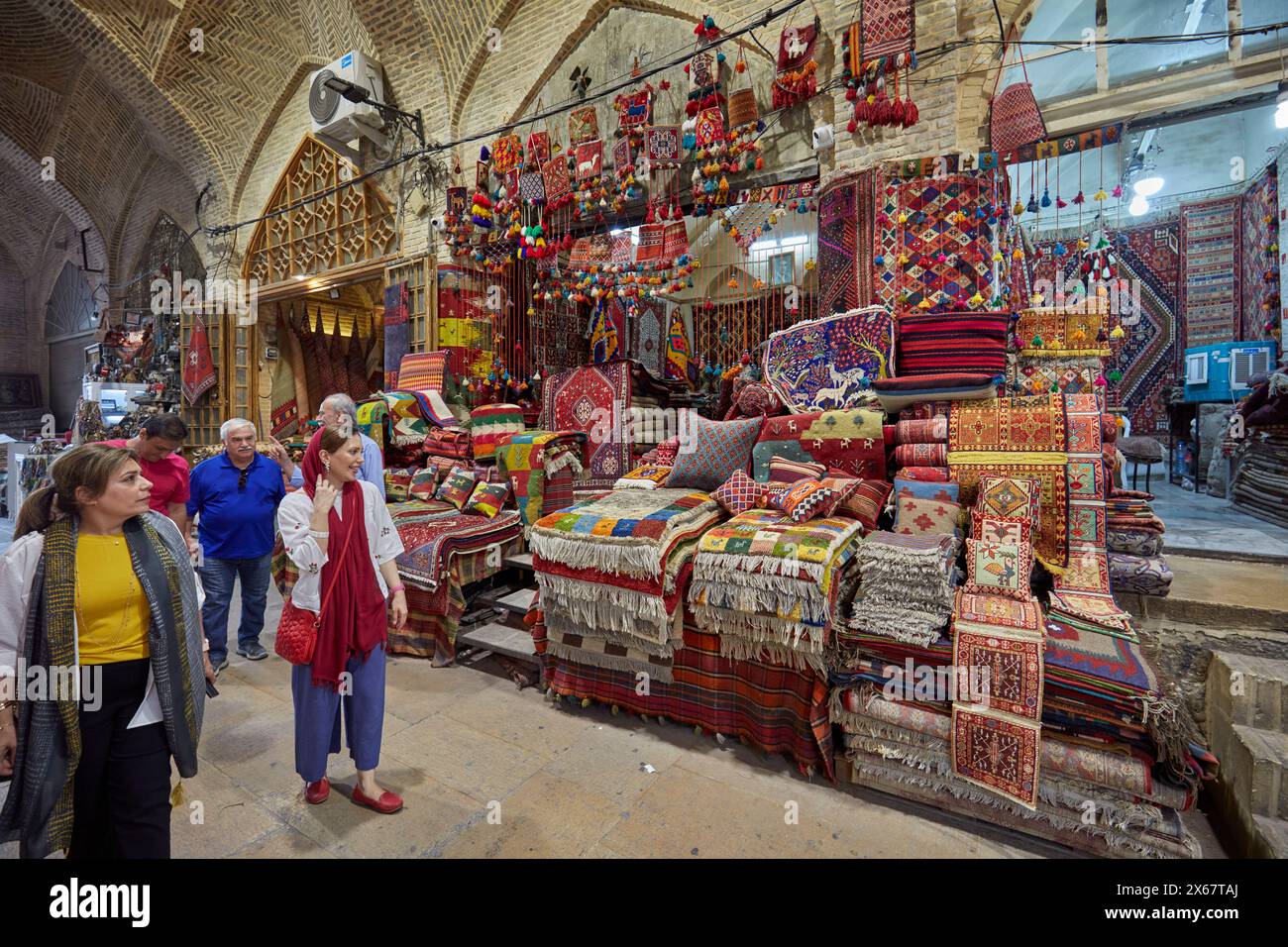 People walk by a handicraft shop in the Vakil Bazaar. Shiraz, Iran ...