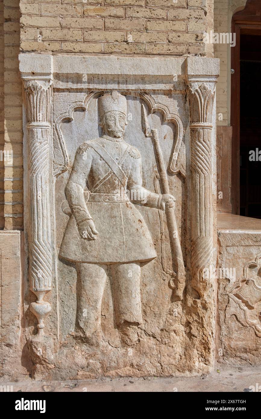 Relief depicting a 19th century Persian soldier with rifle in Qavam ...