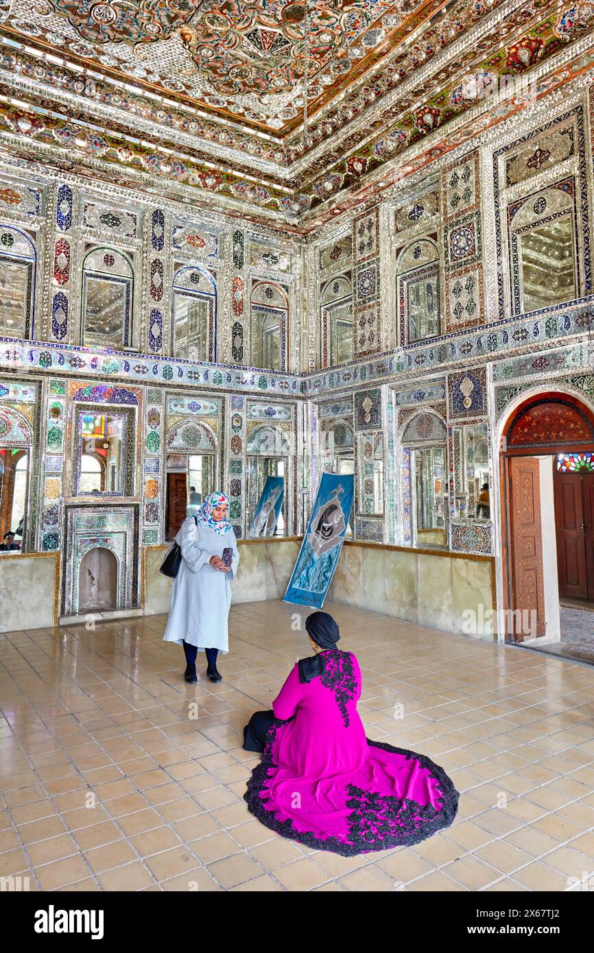 Woman in a fancy dress poses for a photo inside the Zinat Al-Molk ...