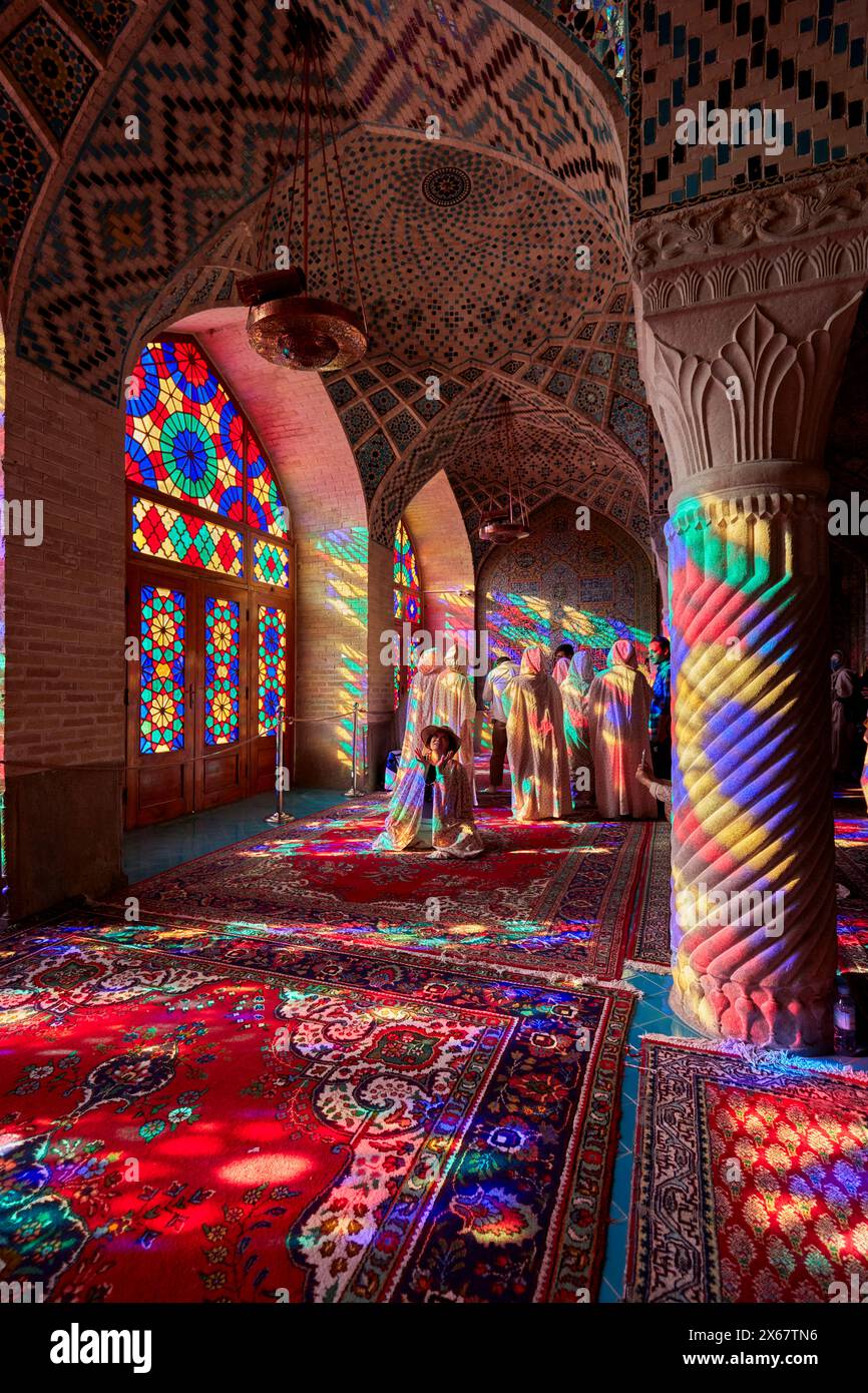 A play of light from multi-colored stained-glass windows inside the ...