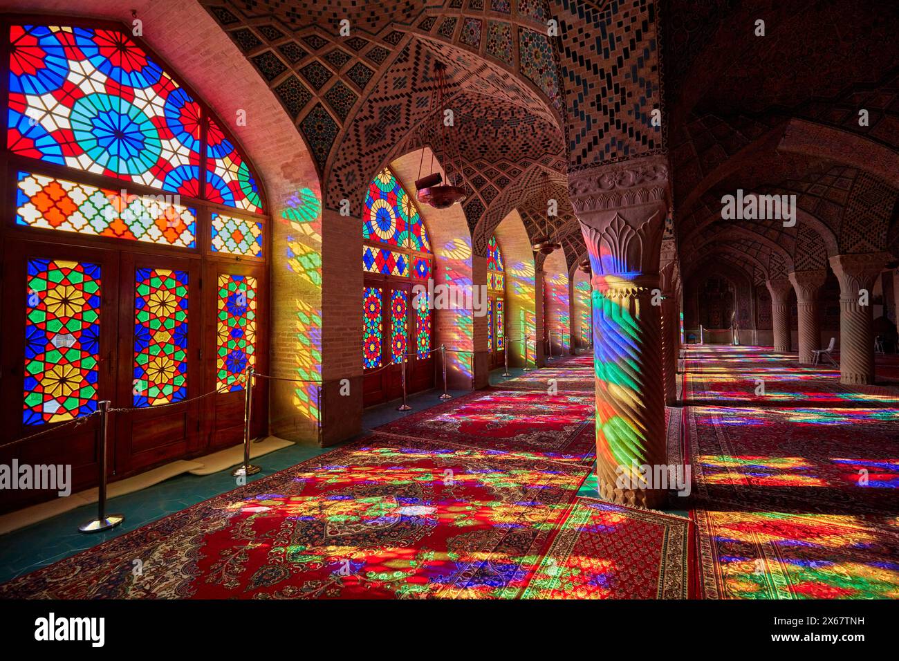 A play of light from multi-colored stained-glass windows inside the ...