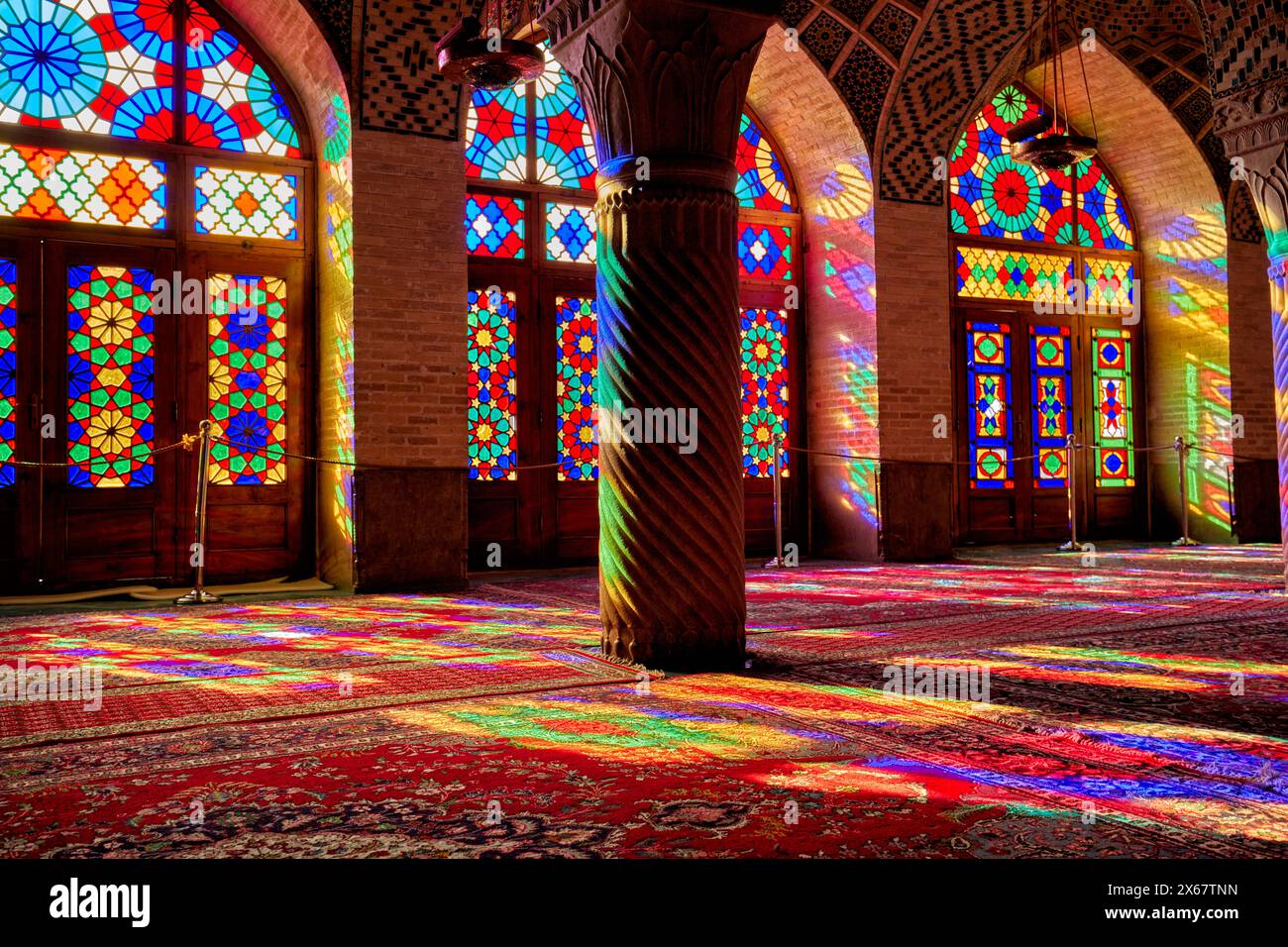 A play of light from multi-colored stained-glass windows inside the ...