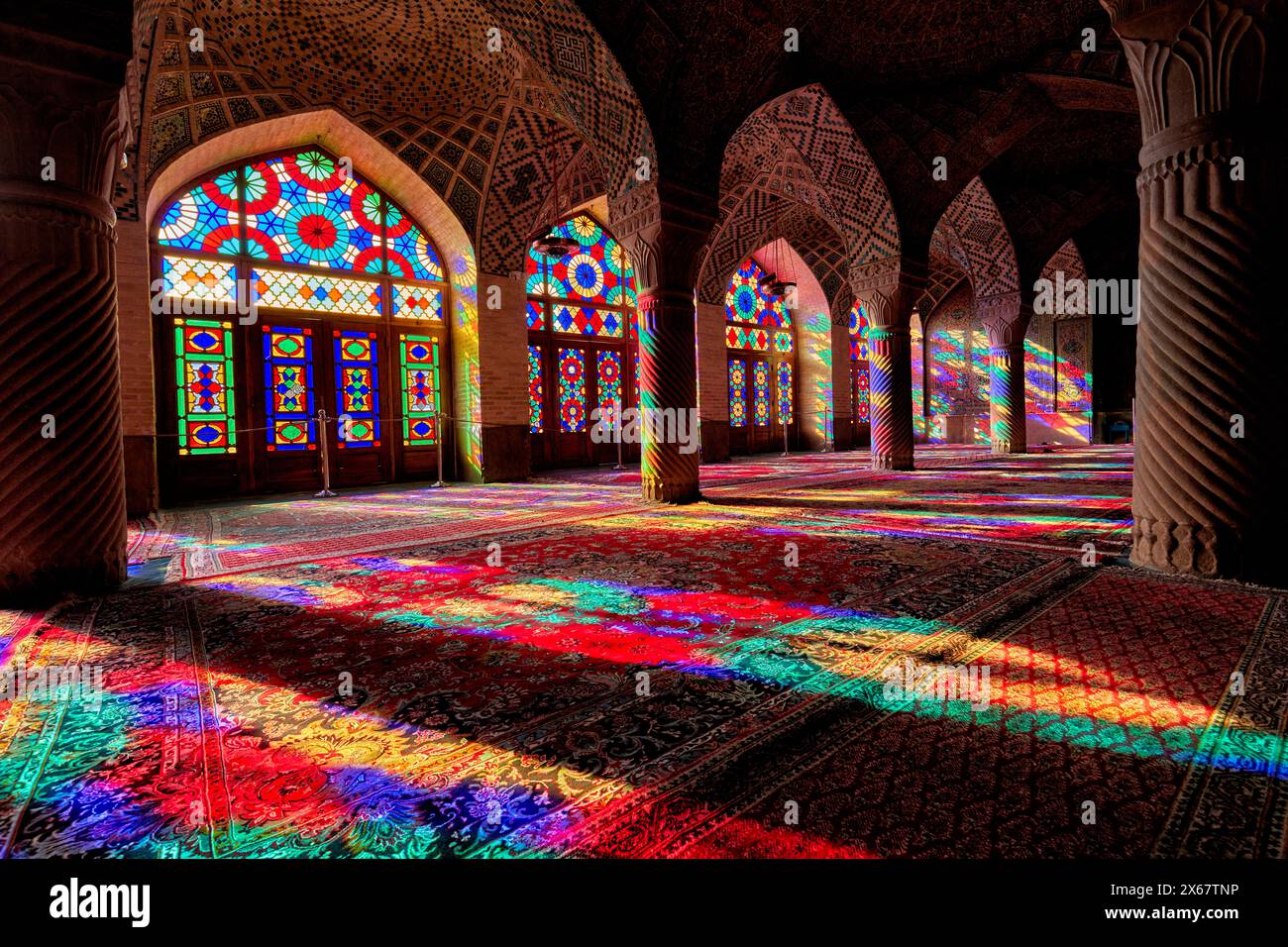 A play of light from multi-colored stained-glass windows inside the ...