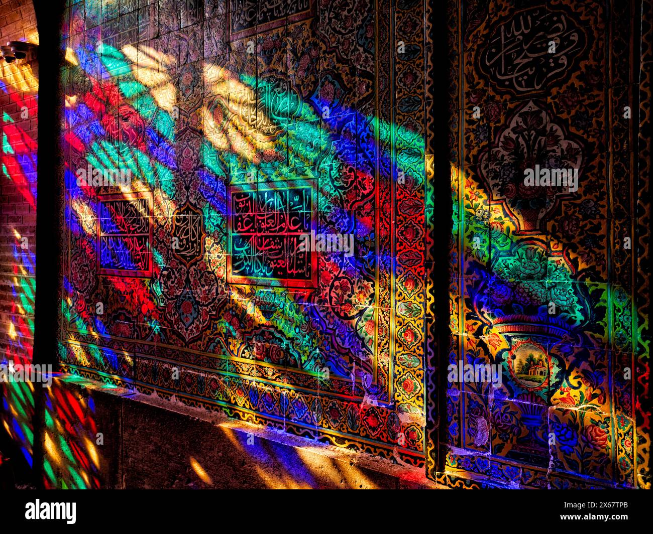 A play of light from multi-colored stained-glass windows inside the ...
