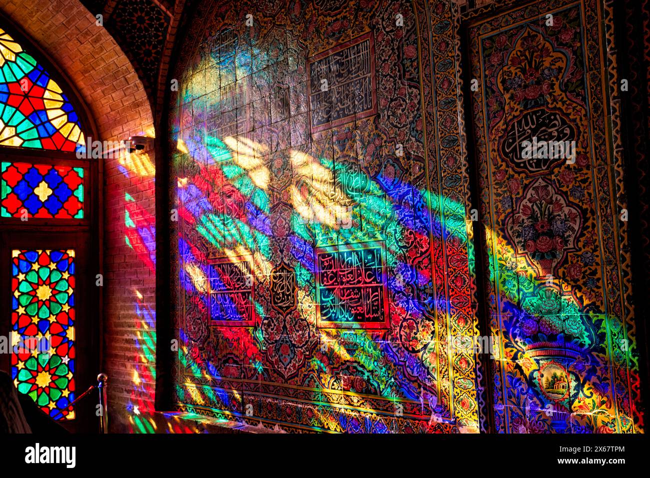 A play of light from multi-colored stained-glass windows inside the ...