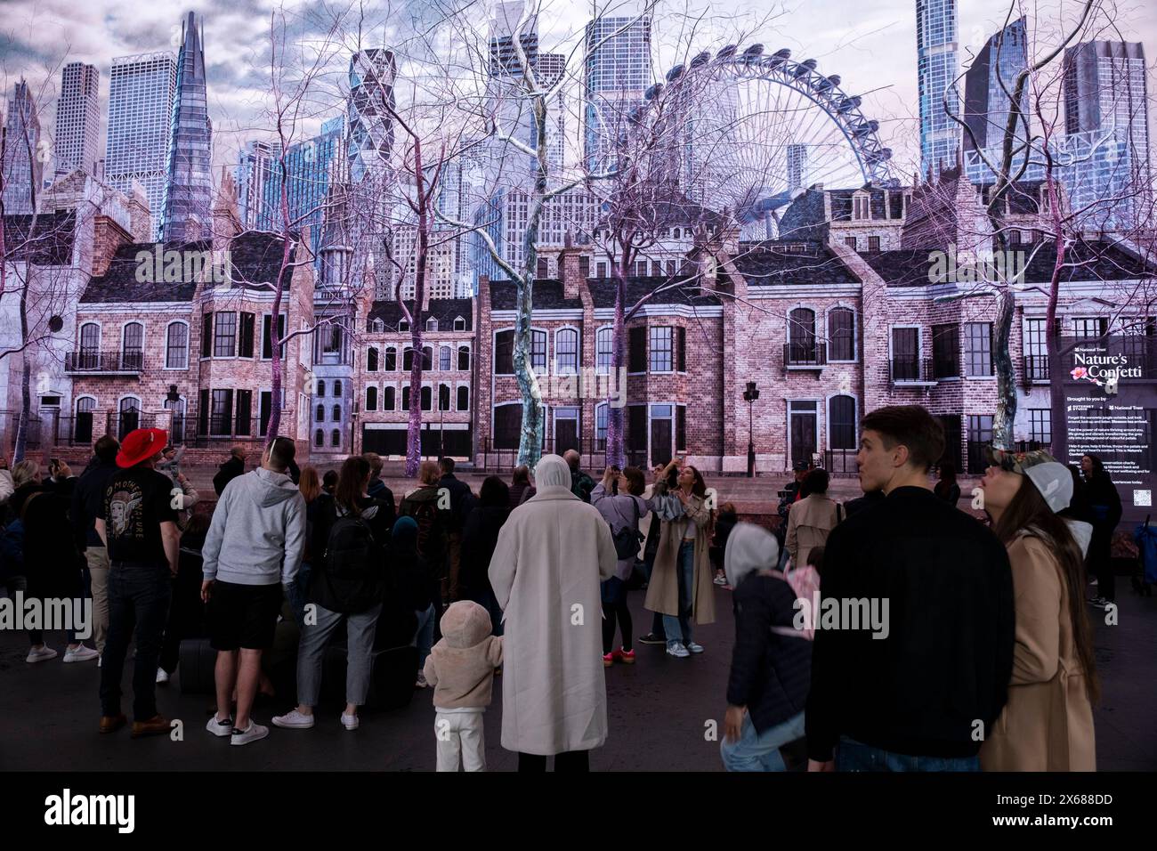 People interact with large scale digital screens displaying a London ...