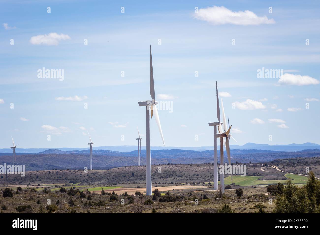 windmills of wind energy in a windfarm in the middle of the countryside ...