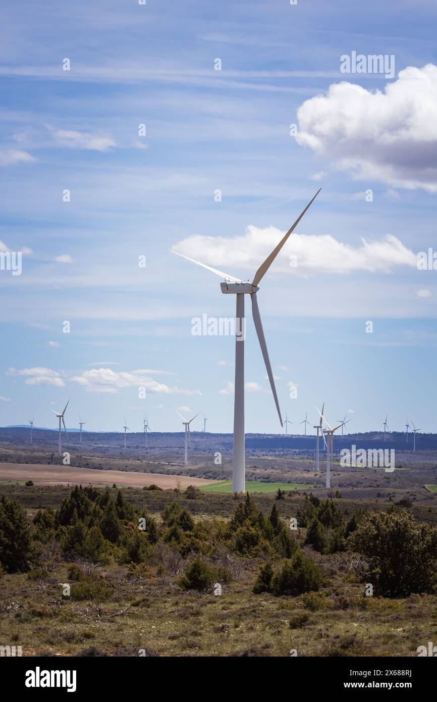windmills of wind energy in a windfarm in the middle of the countryside ...