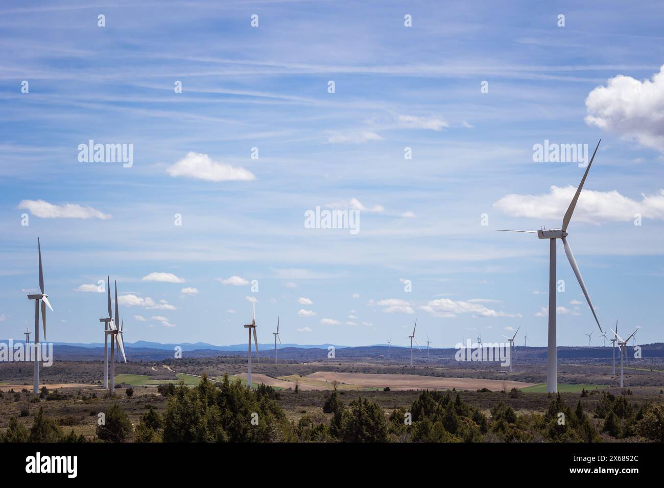 windmills of wind energy in a windfarm in the middle of the countryside ...
