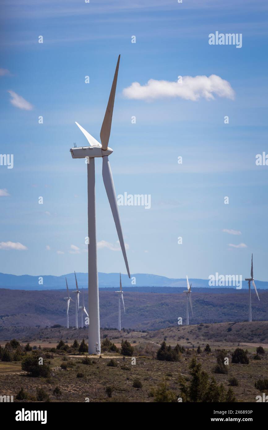 windmills of wind energy in a windfarm in the middle of the countryside ...