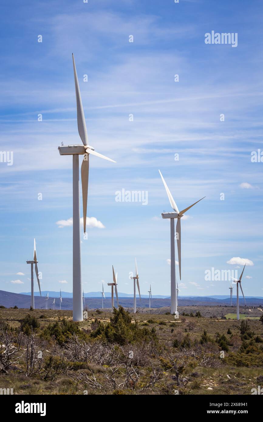 windmills of wind energy in a windfarm in the middle of the countryside ...