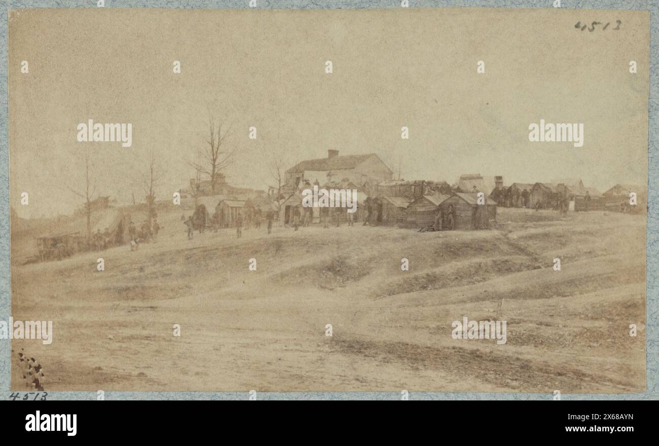 A camp made up of small cabins that surround a large building, Civil ...