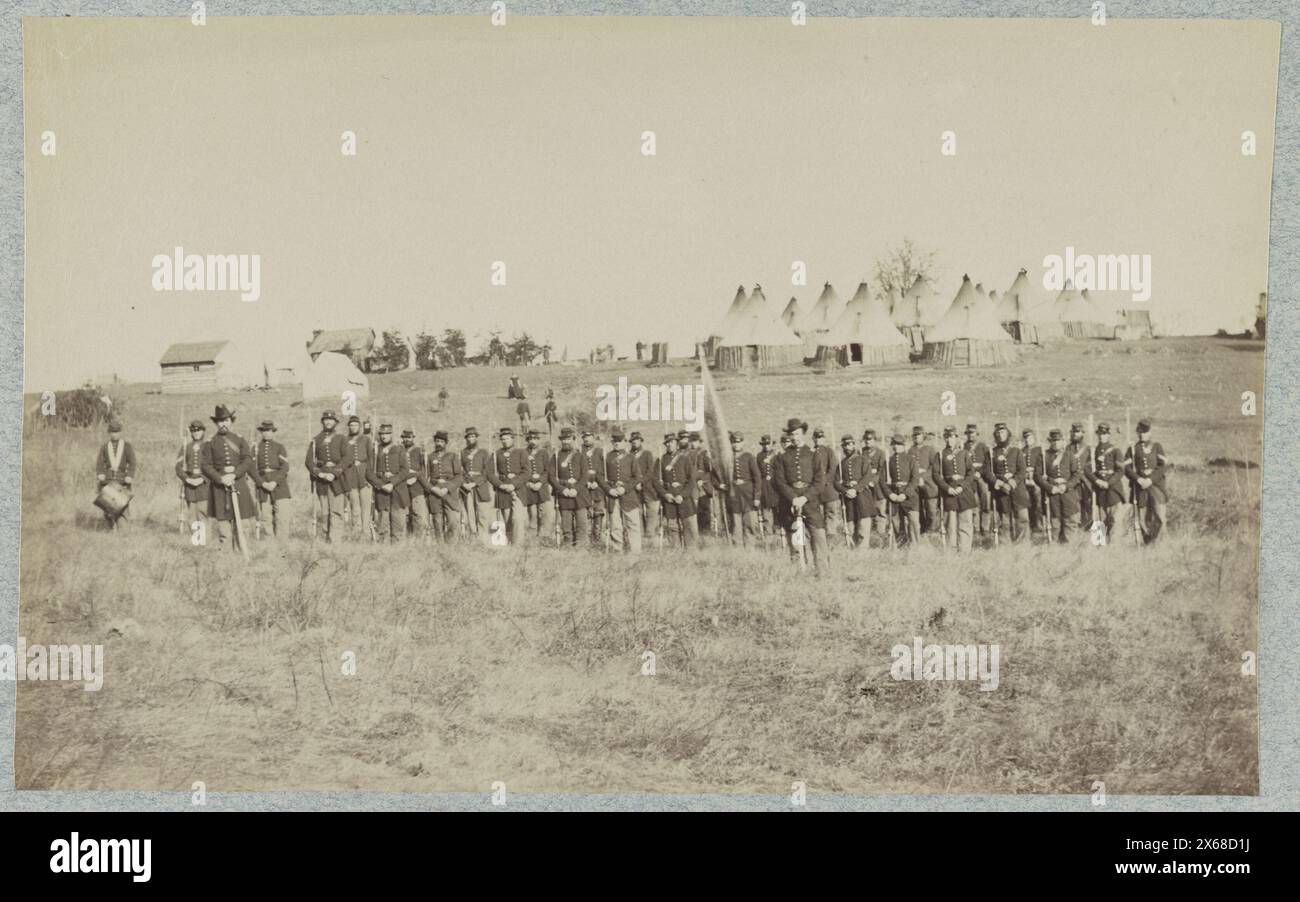 Union soldiers lined up in the field with tents in the background ...