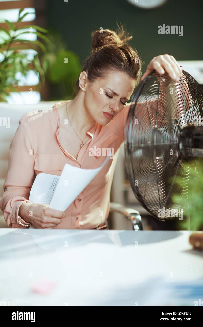 Sustainable workplace. modern female employee at work with documents ...