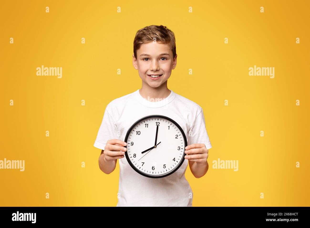 Young Boy Holding Clock Stock Photo - Alamy