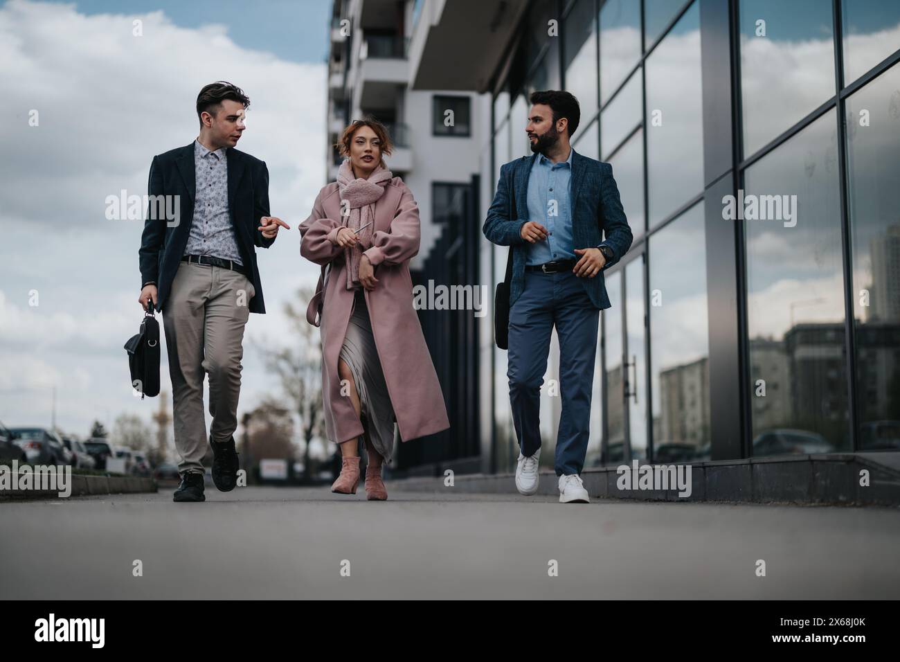 Young business professionals brainstorming during an outdoor meeting in ...