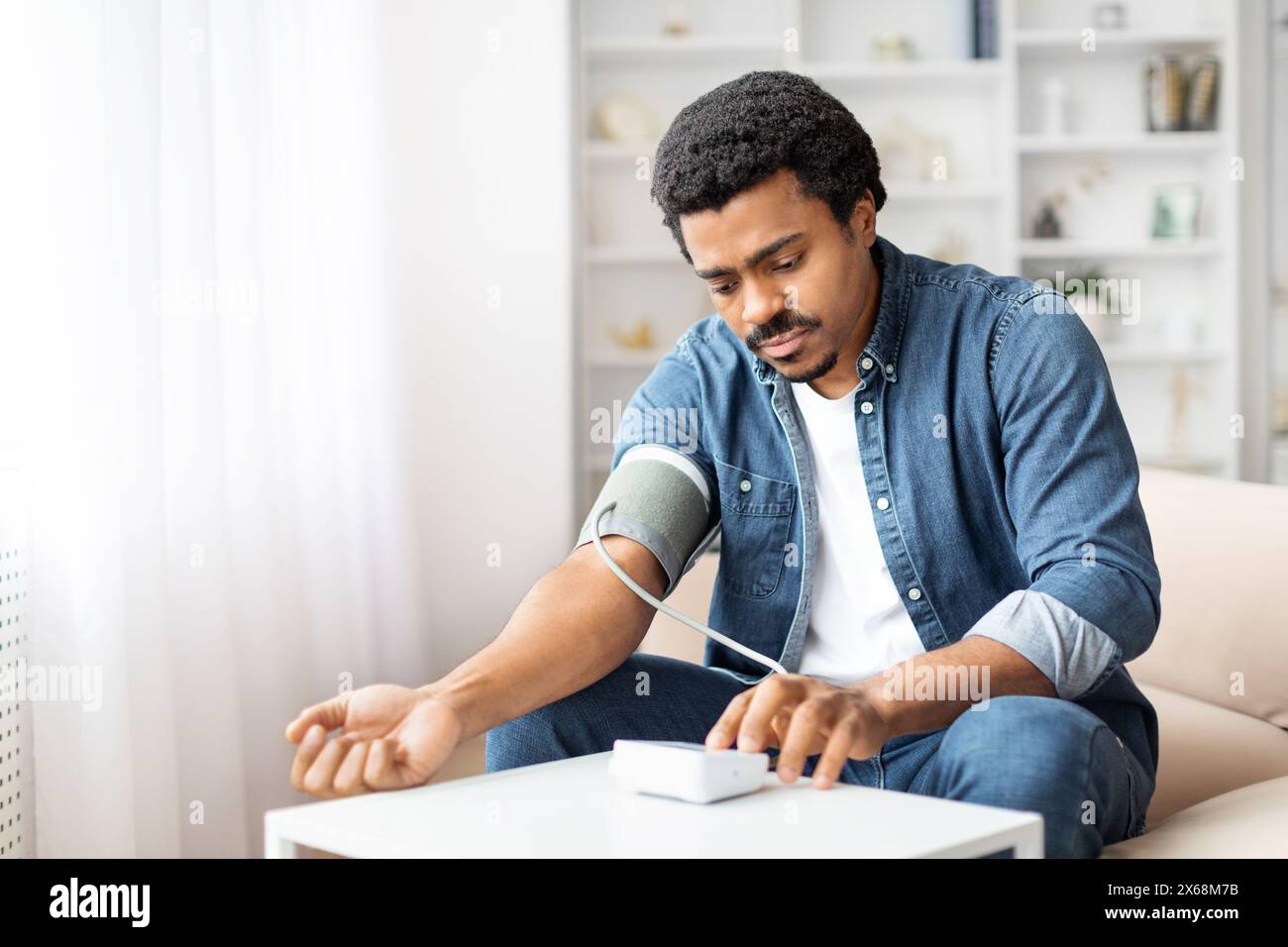 Man Checking His Blood Pressure at Home With Digital Monitor Stock ...