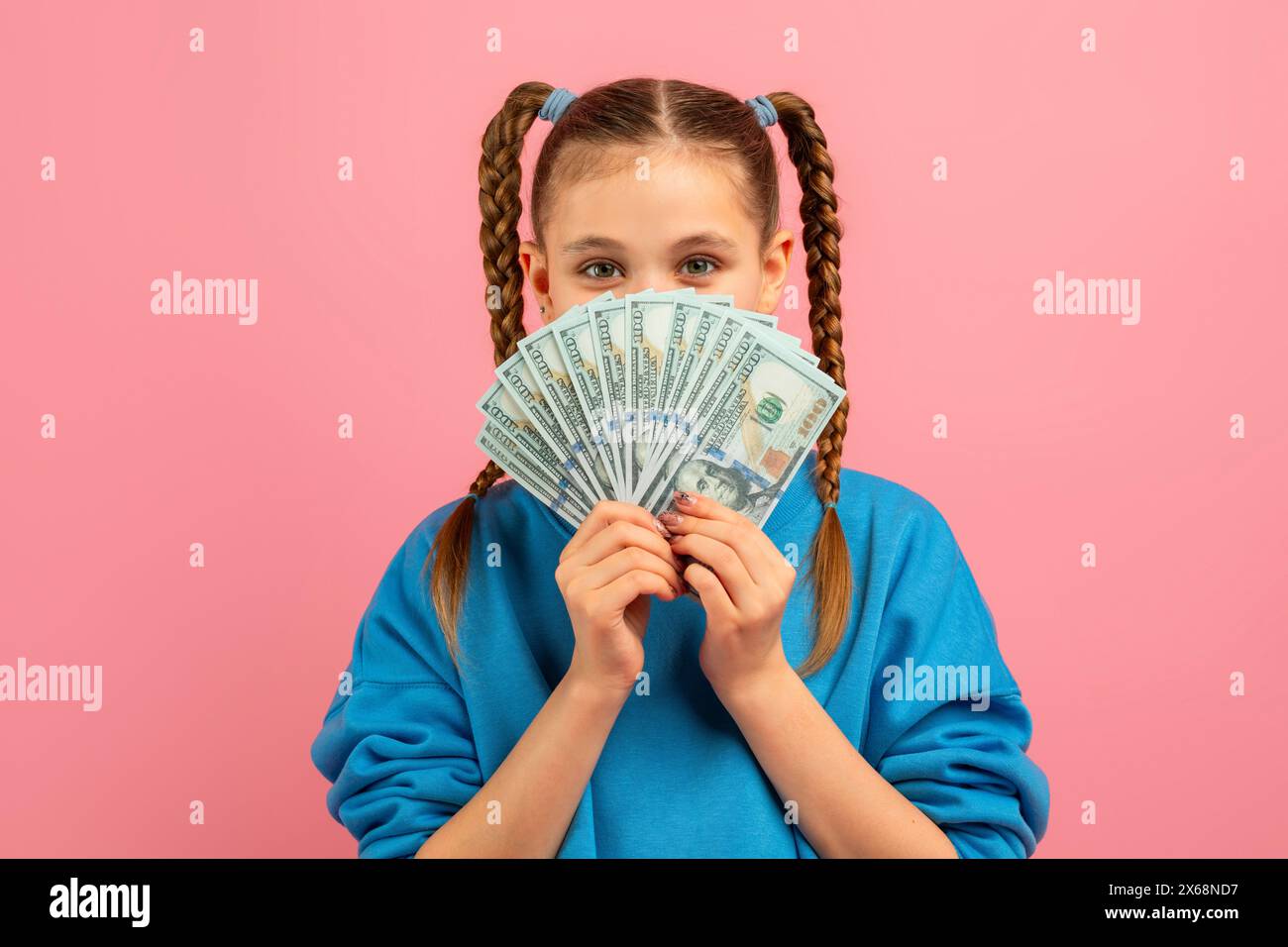 Little Girl Covering Her Face With Money Stock Photo - Alamy
