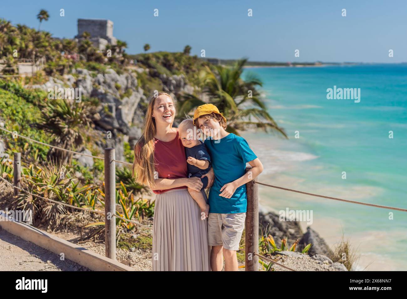Mother and two sons tourists enjoying the view Pre-Columbian Mayan ...