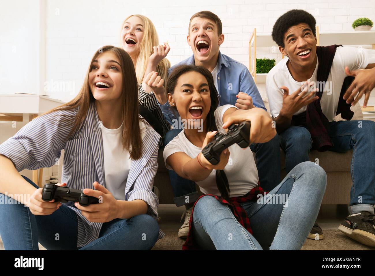 Multiethnic friends playing video games hi-res stock photography and ...