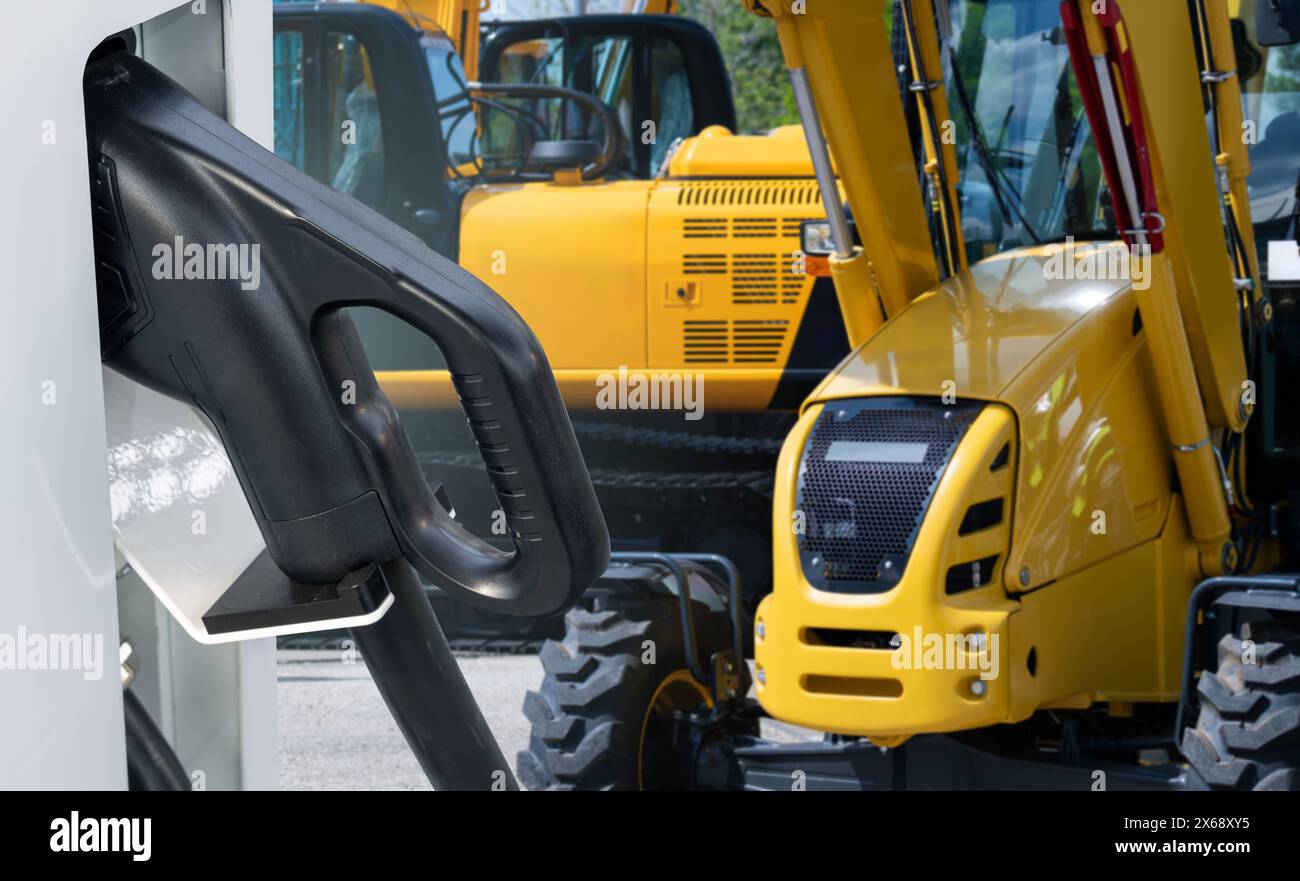Electric construction machines with charging station. Concept Stock ...