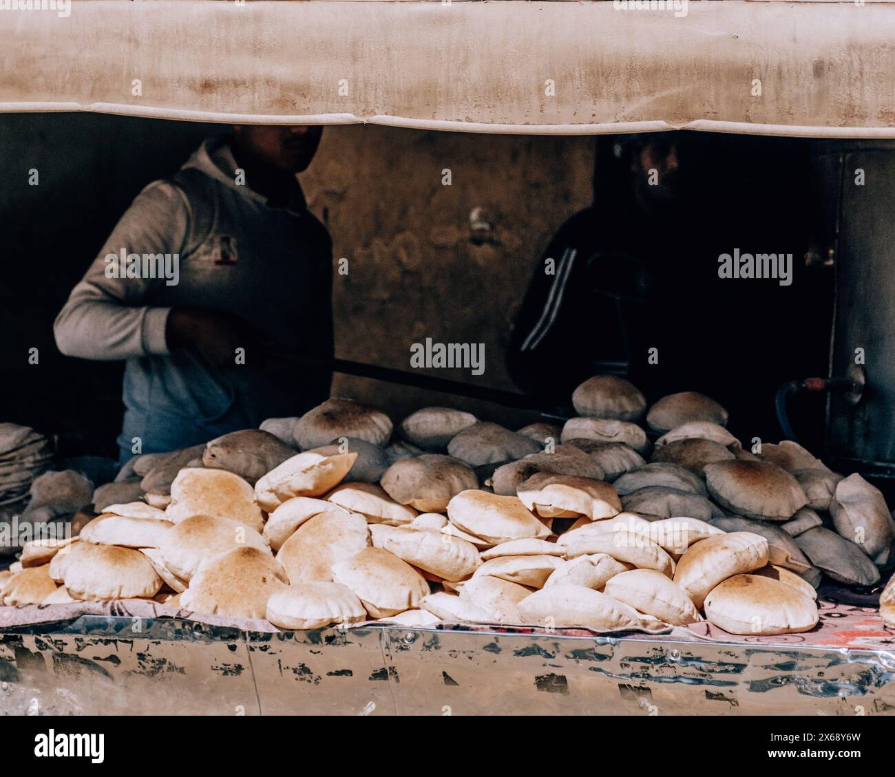 Baker in Siwa Oasis, Egypt, serving fresh traditional bread Stock Photo ...