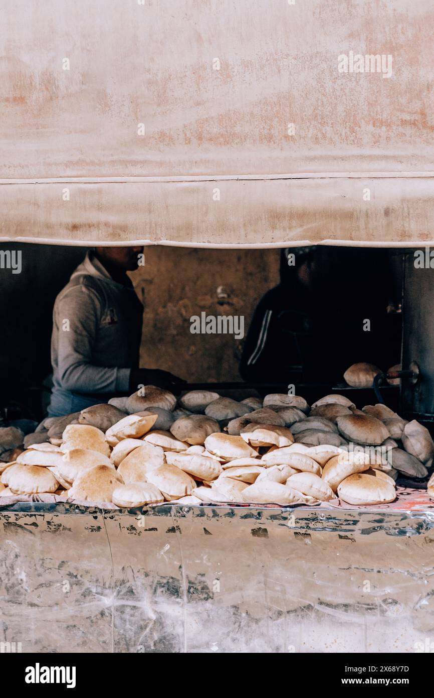 Baker in Siwa Oasis, Egypt, serving fresh traditional bread Stock Photo ...