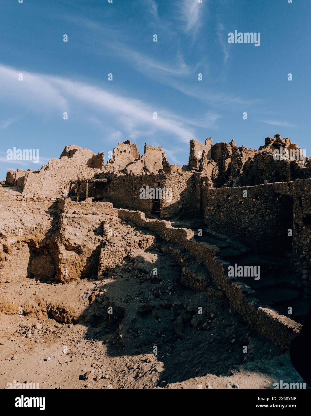Ancient stone ruins of the Oracle Temple under a blue sky, Siwa Oasis ...