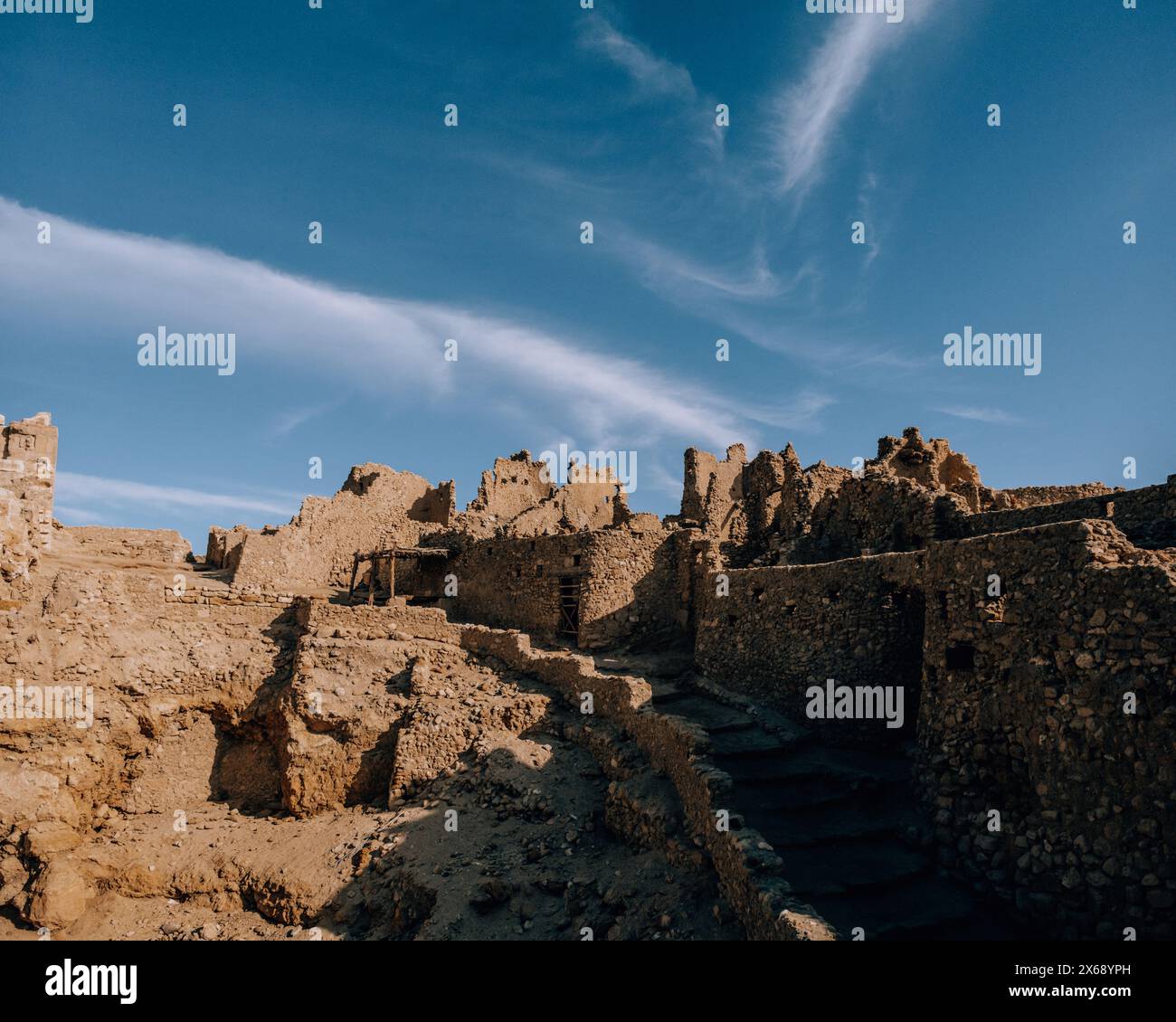 Ancient stone ruins of the Oracle Temple under a blue sky, Siwa Oasis ...