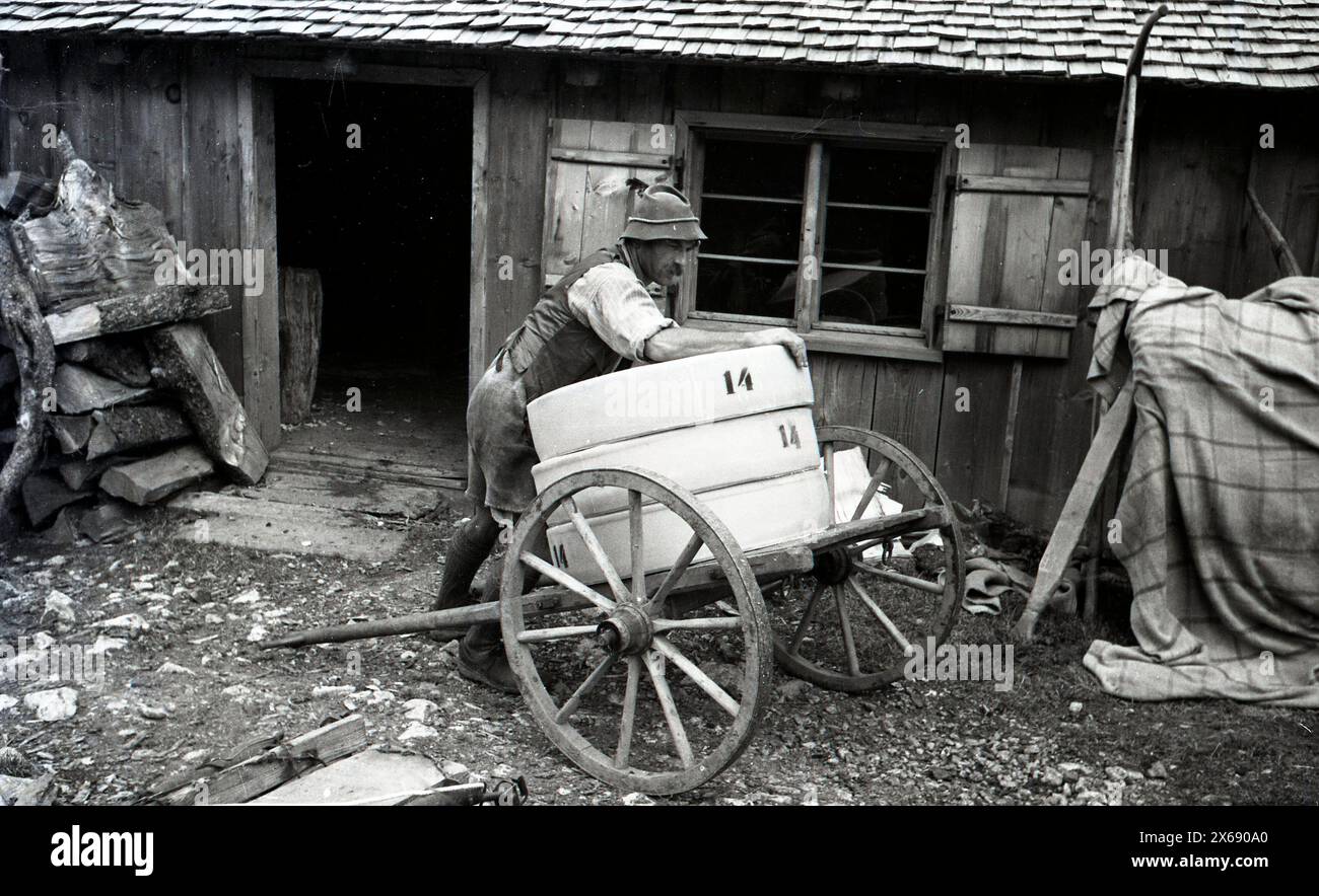 Man loading cheese onto a cart, 1949, Alpe Plättele, Allgäu, Bavaria ...