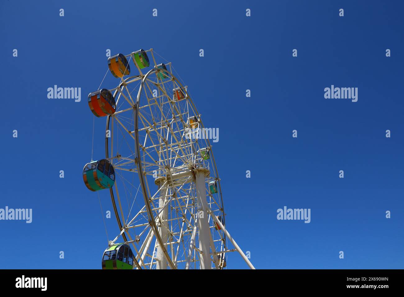Clear blue sky and cute Ferris wheel Stock Photo - Alamy