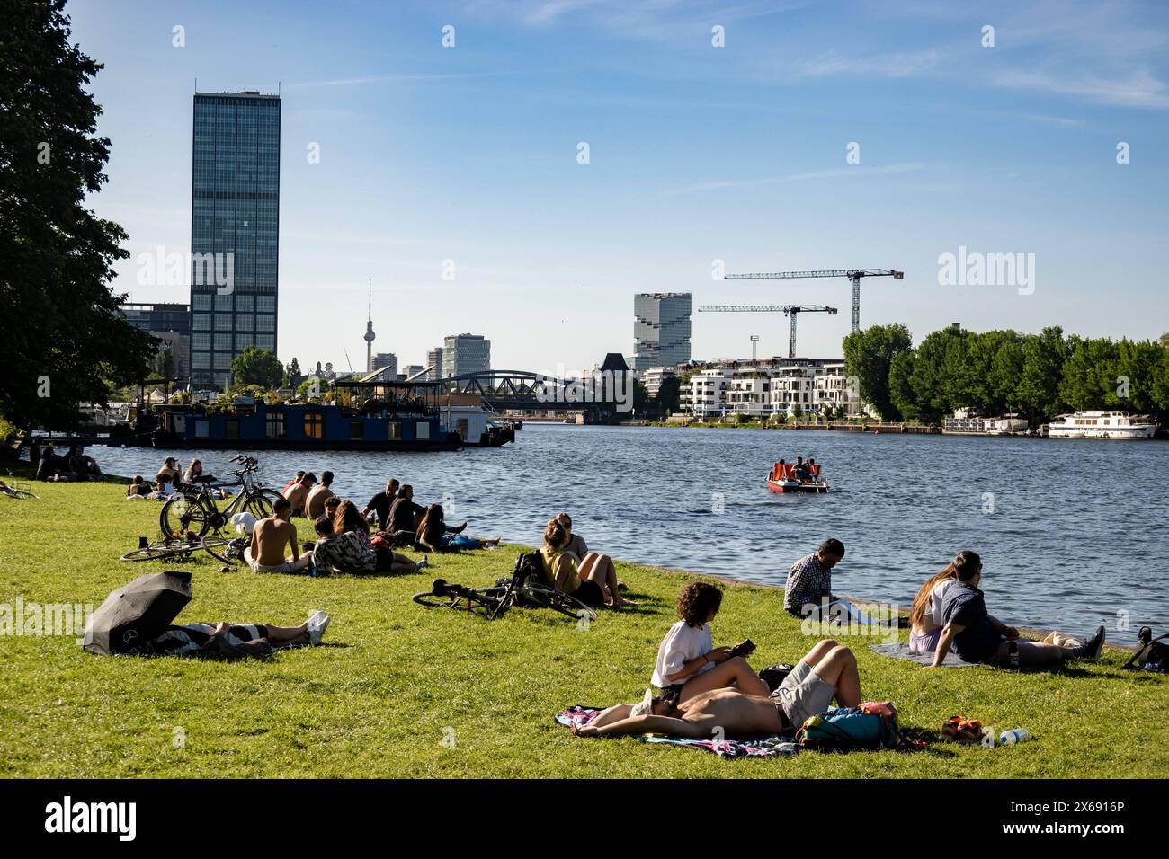 Menschen geniessen den sonnigen Frühlingstag am Spreeufer im Treptower ...